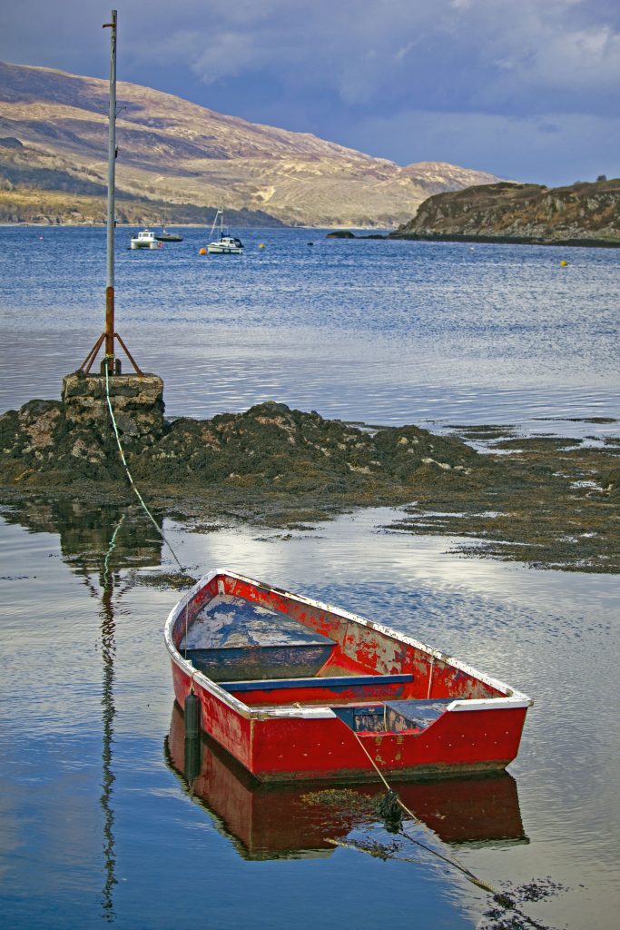 Red Boat on Water Scotland - We Said Go Travel